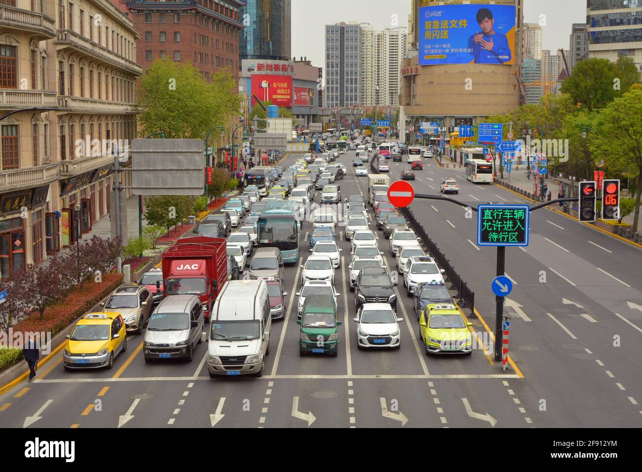 Rush hour traffic queued up at a set of traffic lights on a street in ...