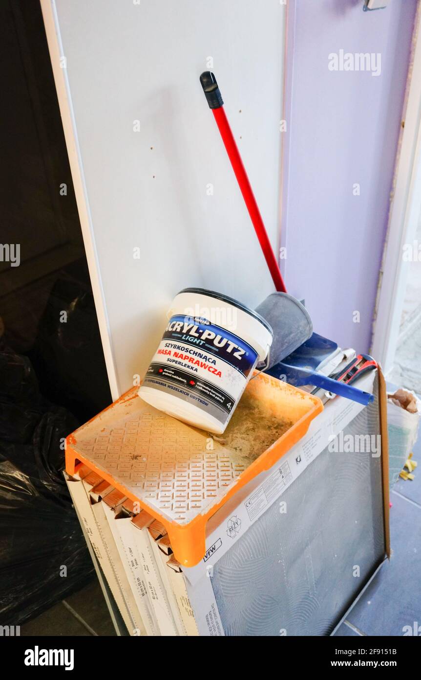 POZNAN, POLAND - Apr 15, 2016: Paint bucket on large packed tiles in a ...