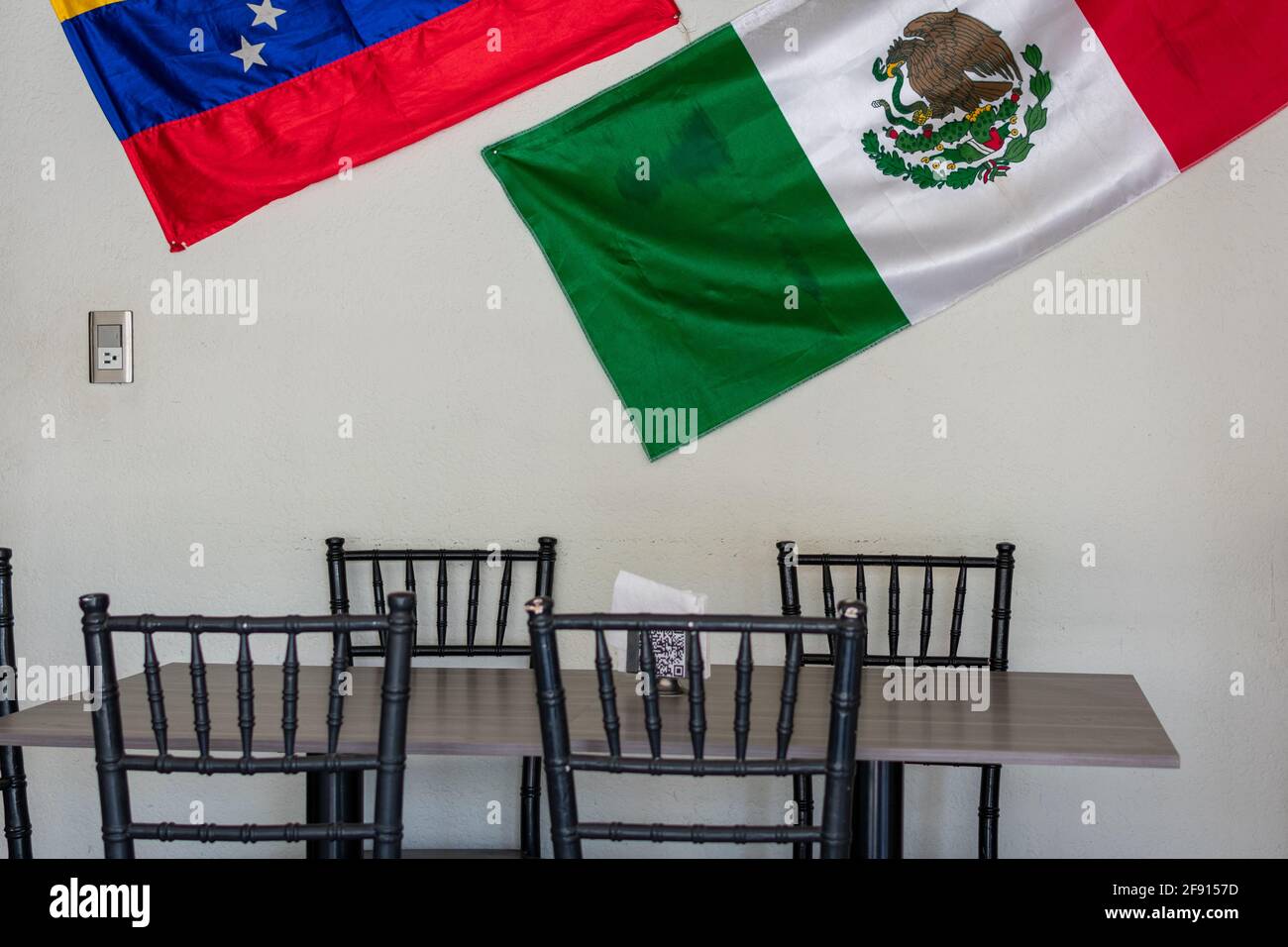 Restaurant with tables for dinners with the flags of Mexico and ...