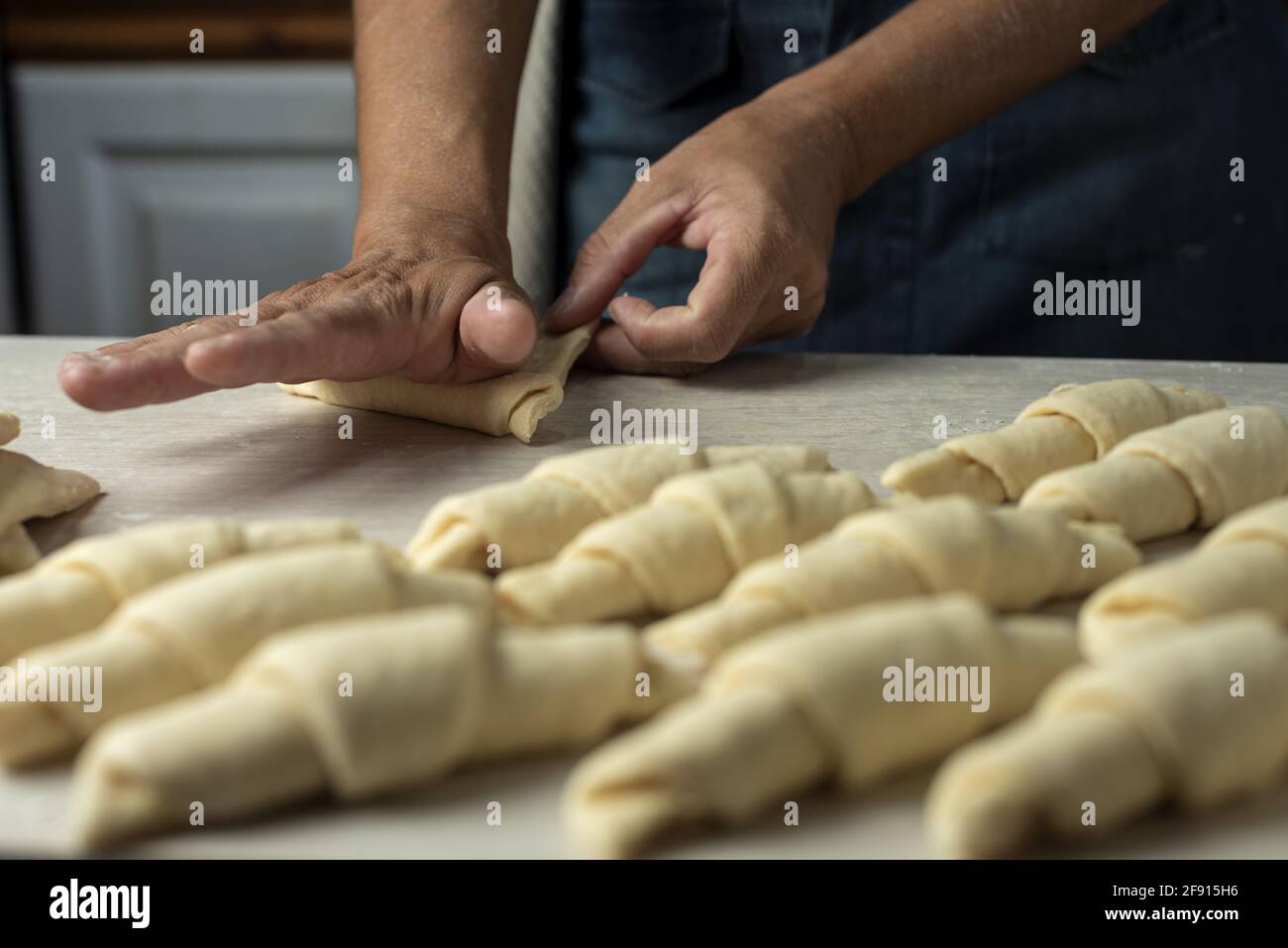 Closeup of a baker making croissants in the kitchen Stock Photo - Alamy