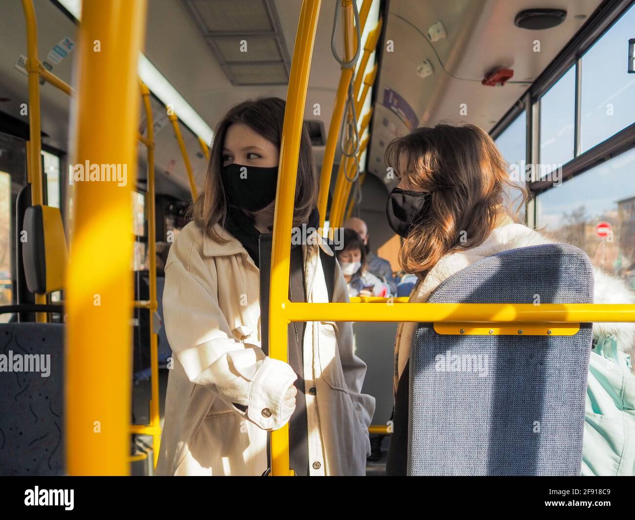 Moscow. Russia. April 12, 2021. Two cheerful girls in protective masks ...