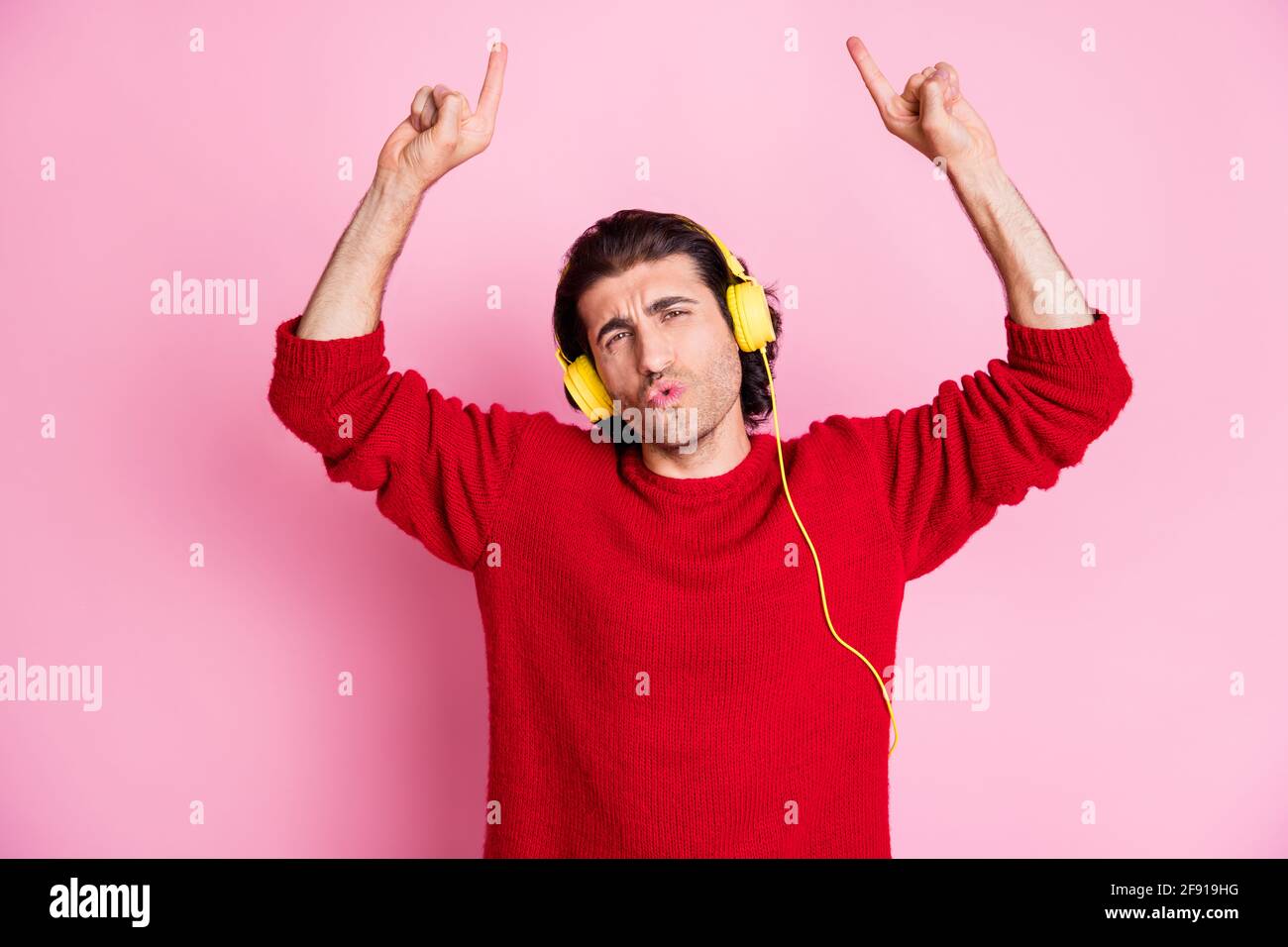 Photo of young man have fun listen music earphones gesture fingers ...