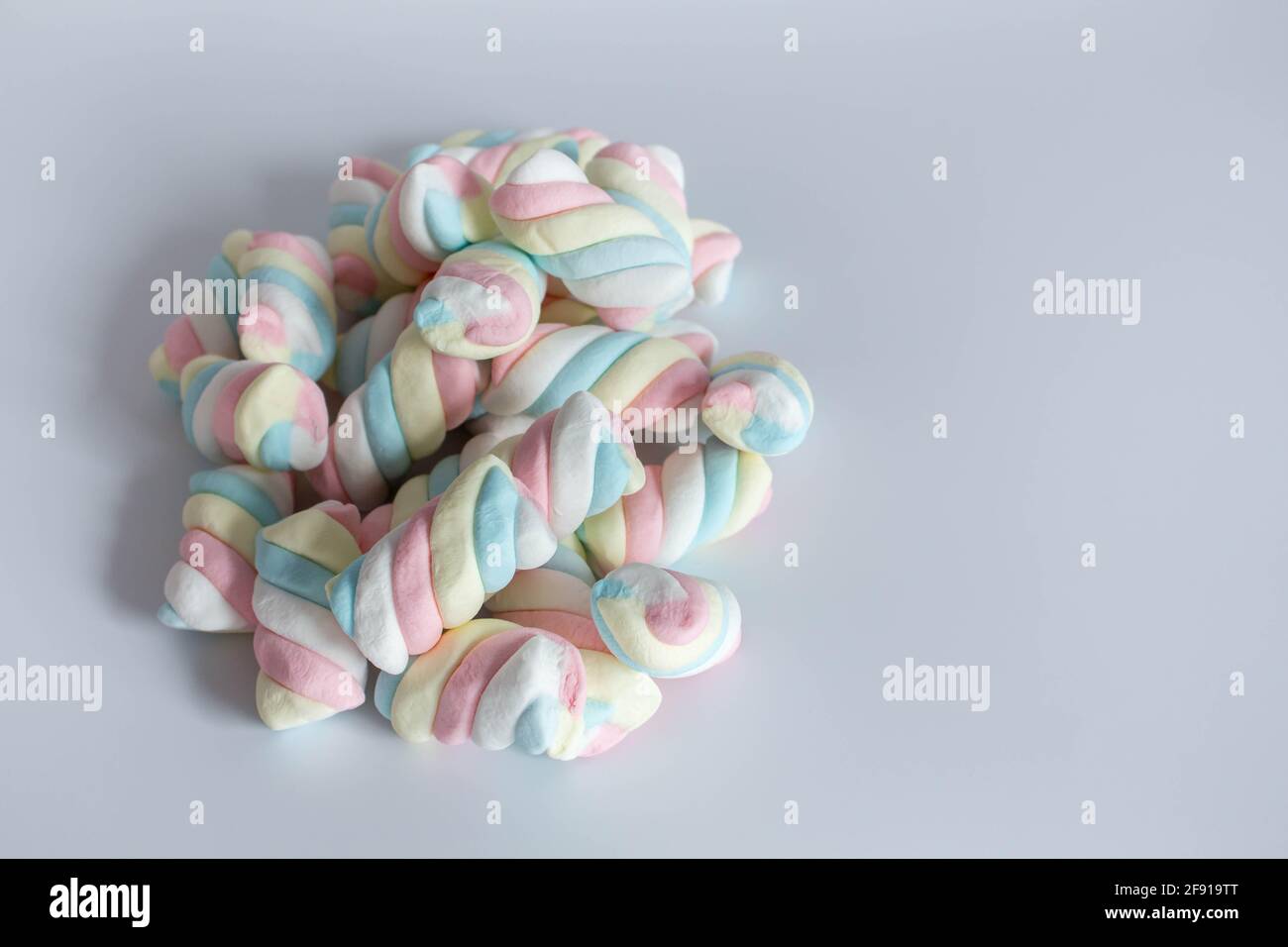 Colored twisted marshmallow on white Stock Photo - Alamy