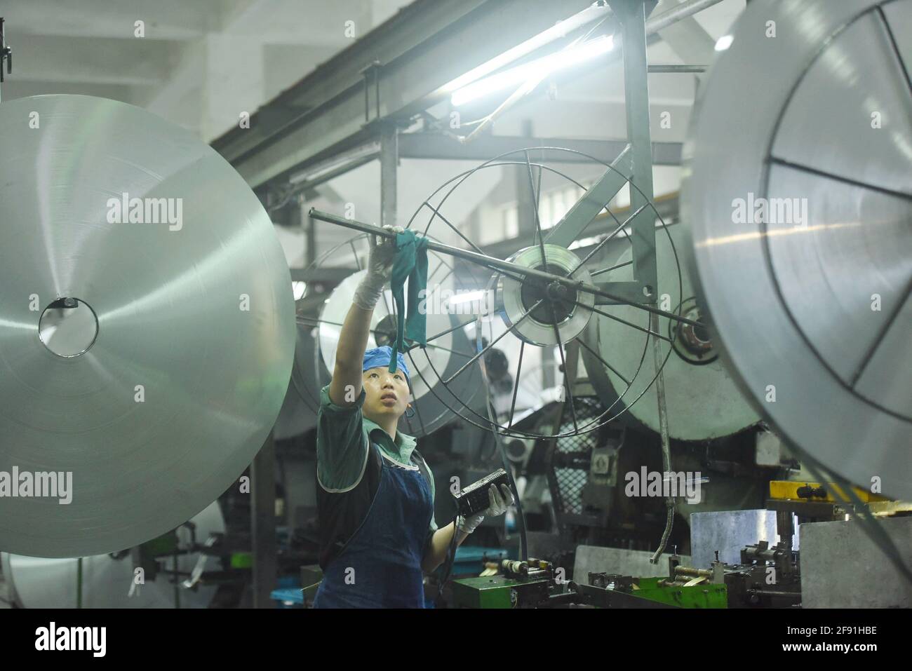 HANGZHOU, CHINA - APRIL 16, 2021 - A worker processes aluminum used in ...