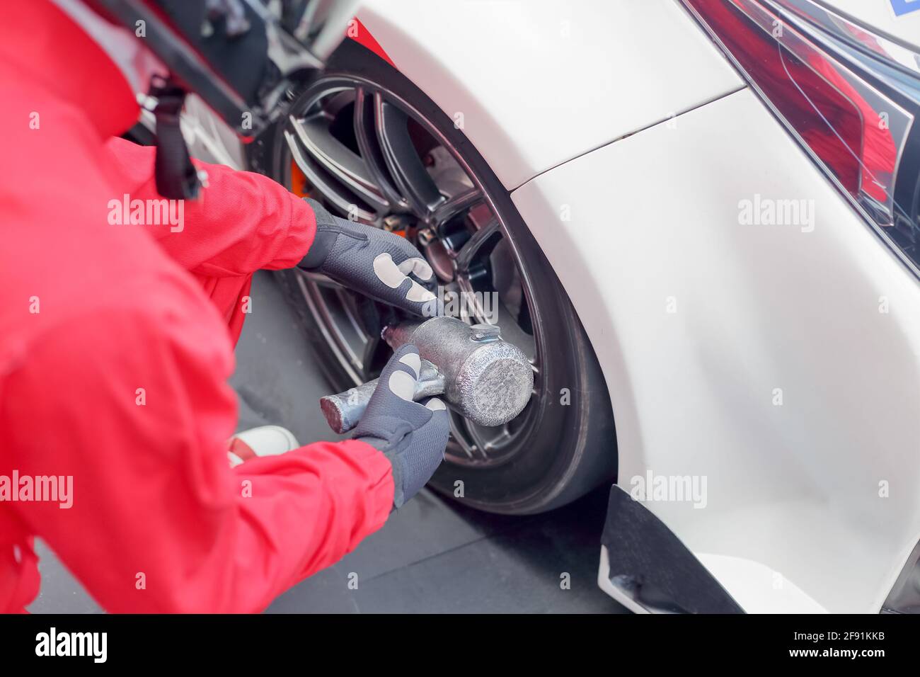 Auto mechanic changing racing car wheel Stock Photo - Alamy