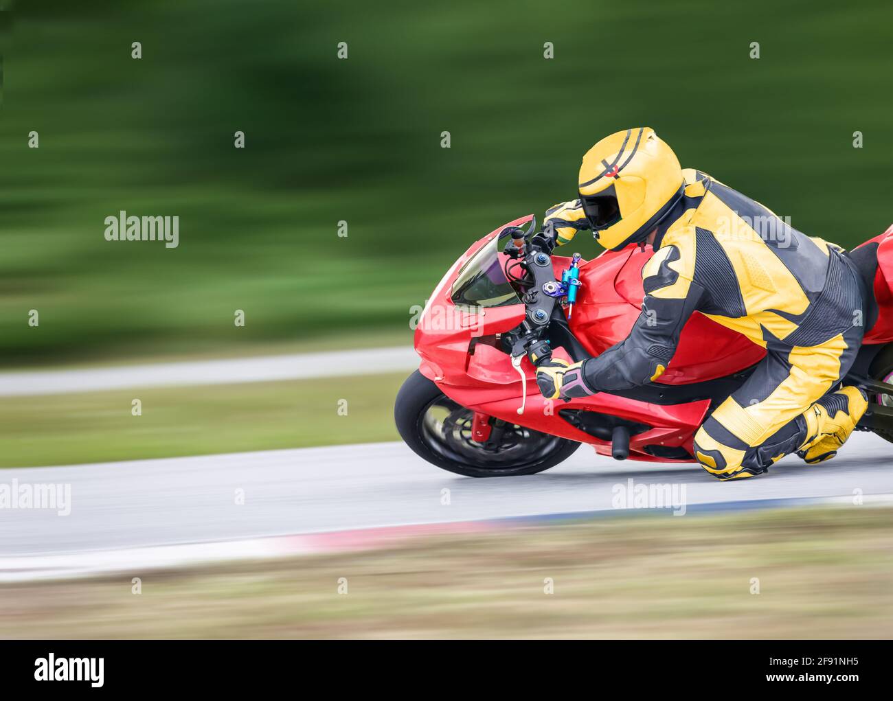 Motorcycle practice leaning into a fast corner on track Stock Photo - Alamy