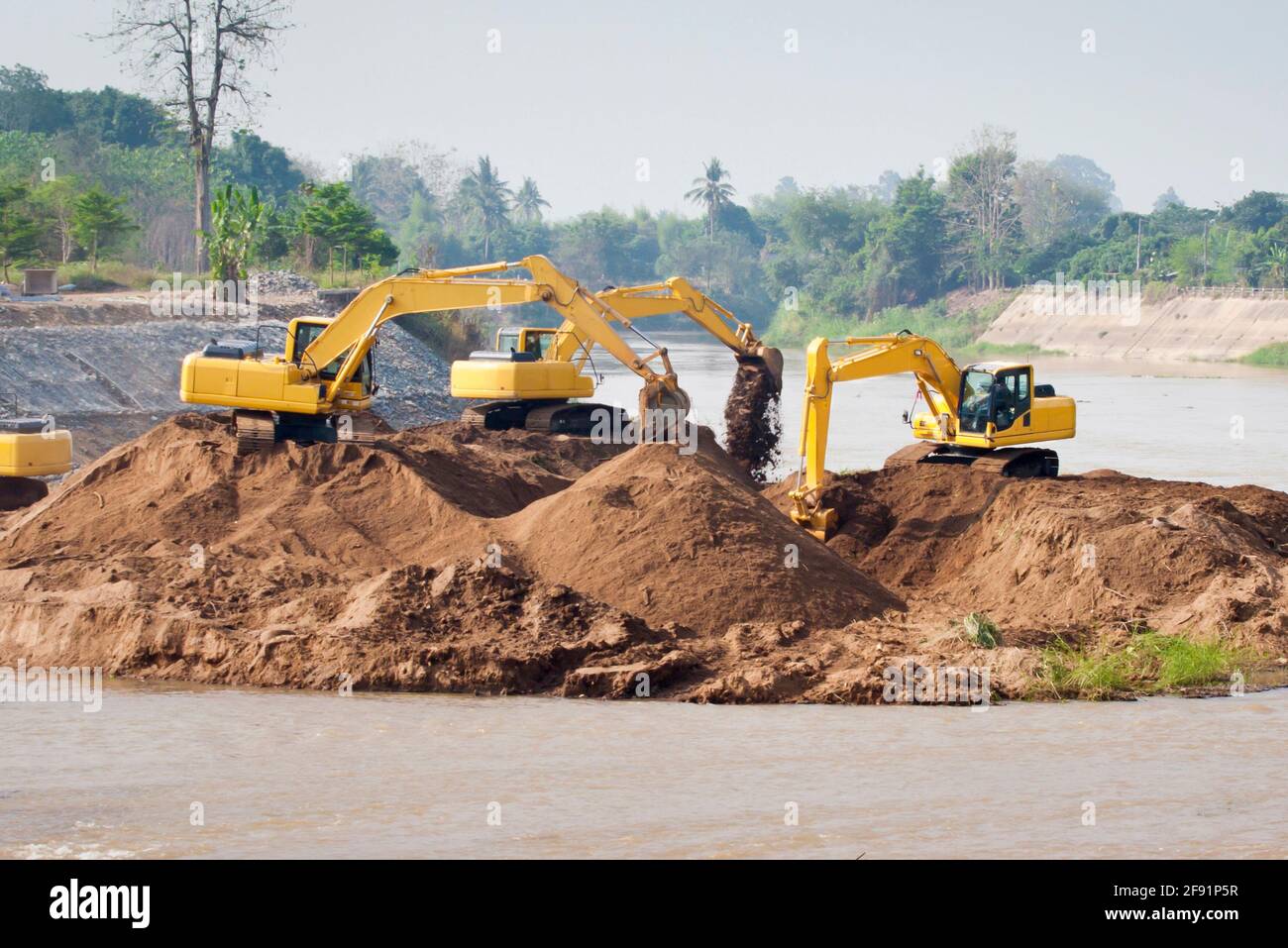 excavator machine group works at river for protect flood Stock Photo ...