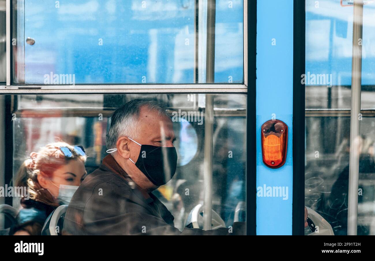ZAGREB, CROATIA - Mar 24, 2021: Adult man sitting by window in public ...