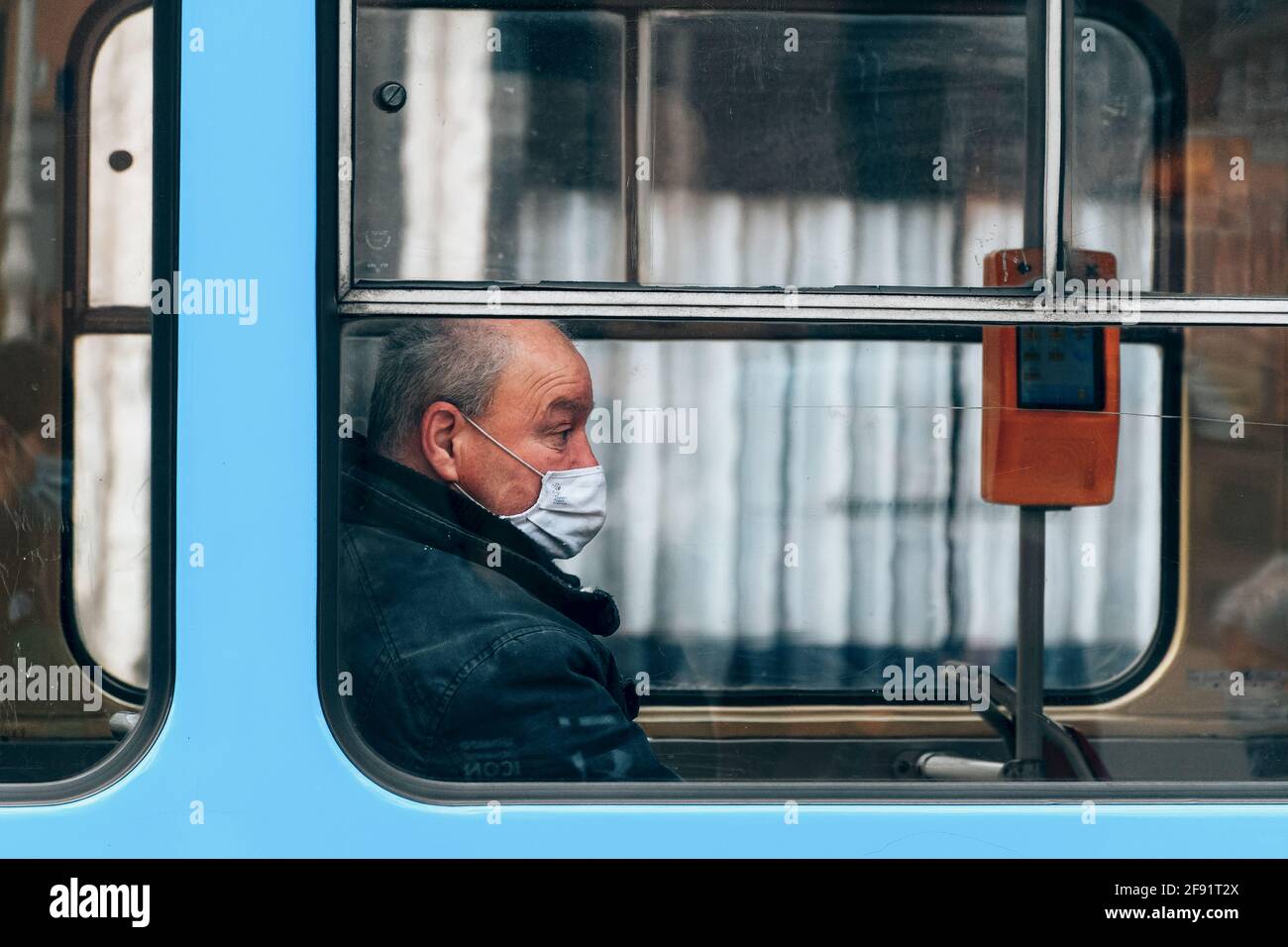 ZAGREB, CROATIA - Mar 24, 2021: Adult man sitting by window in public ...