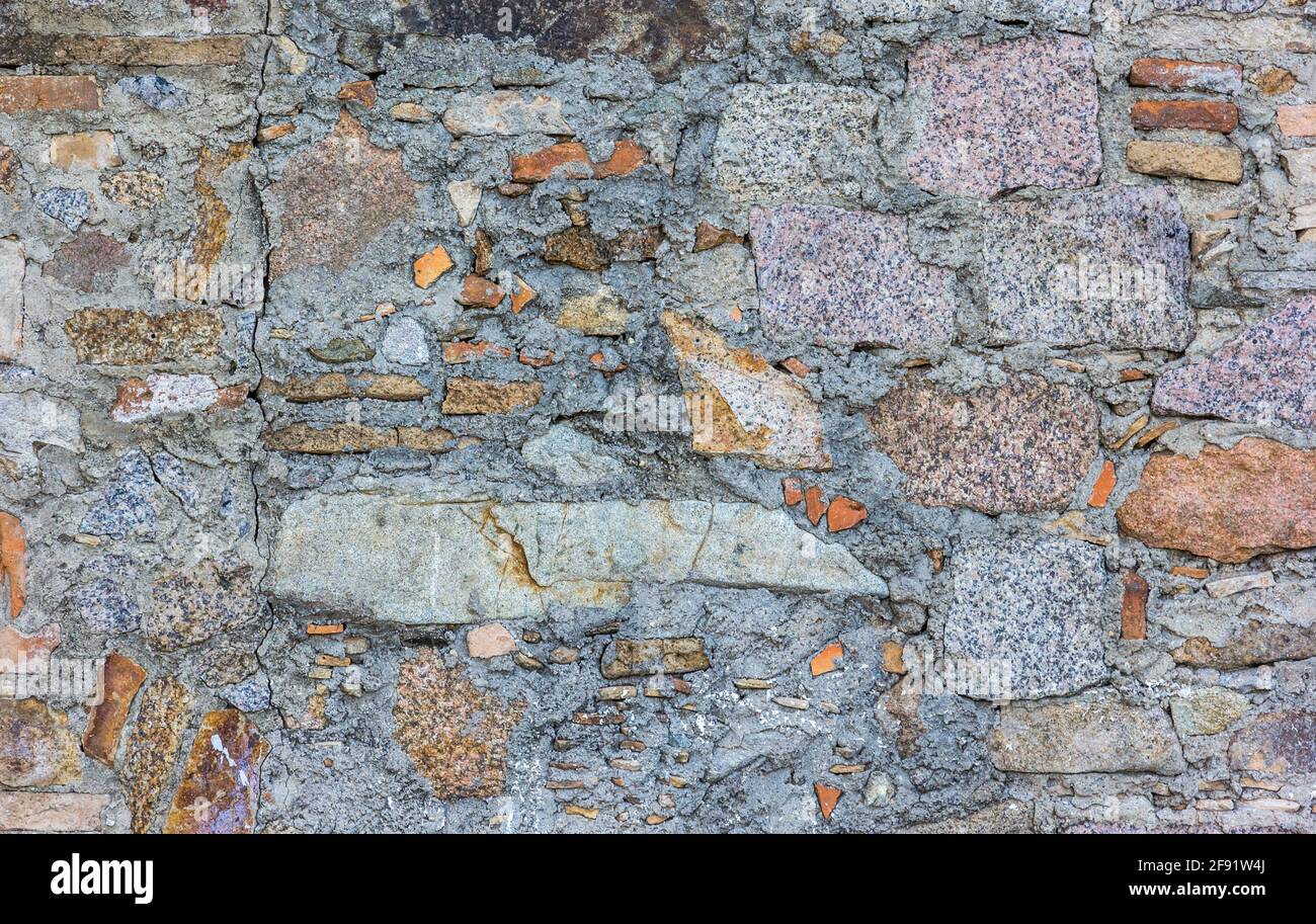 Old stone wall textured background made of different stones Stock Photo ...