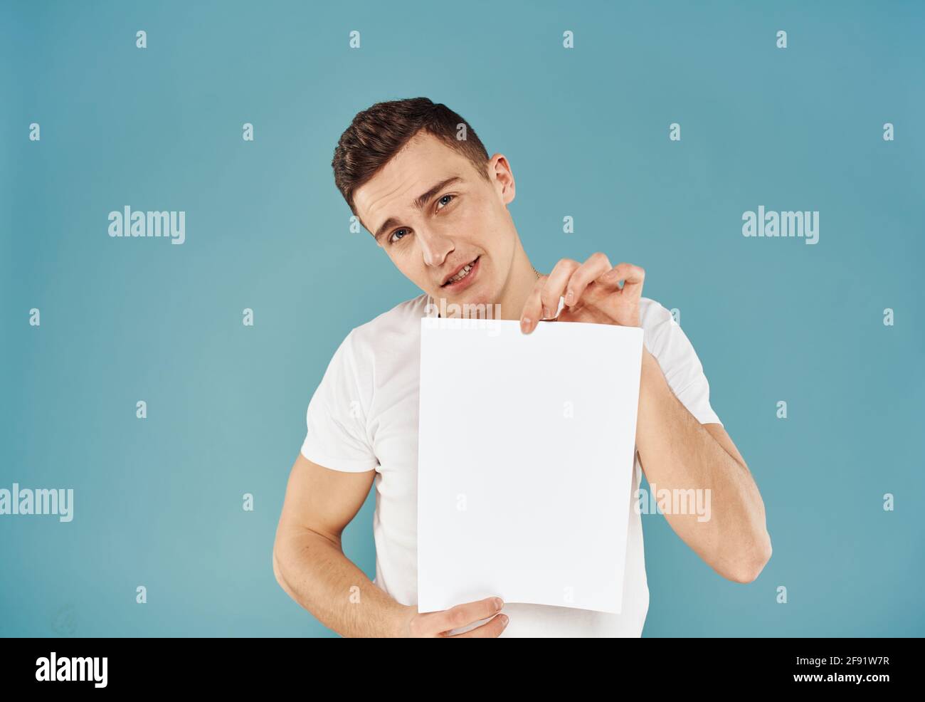 Man Holding Flyer Poster mockup blue background cropped view Stock ...