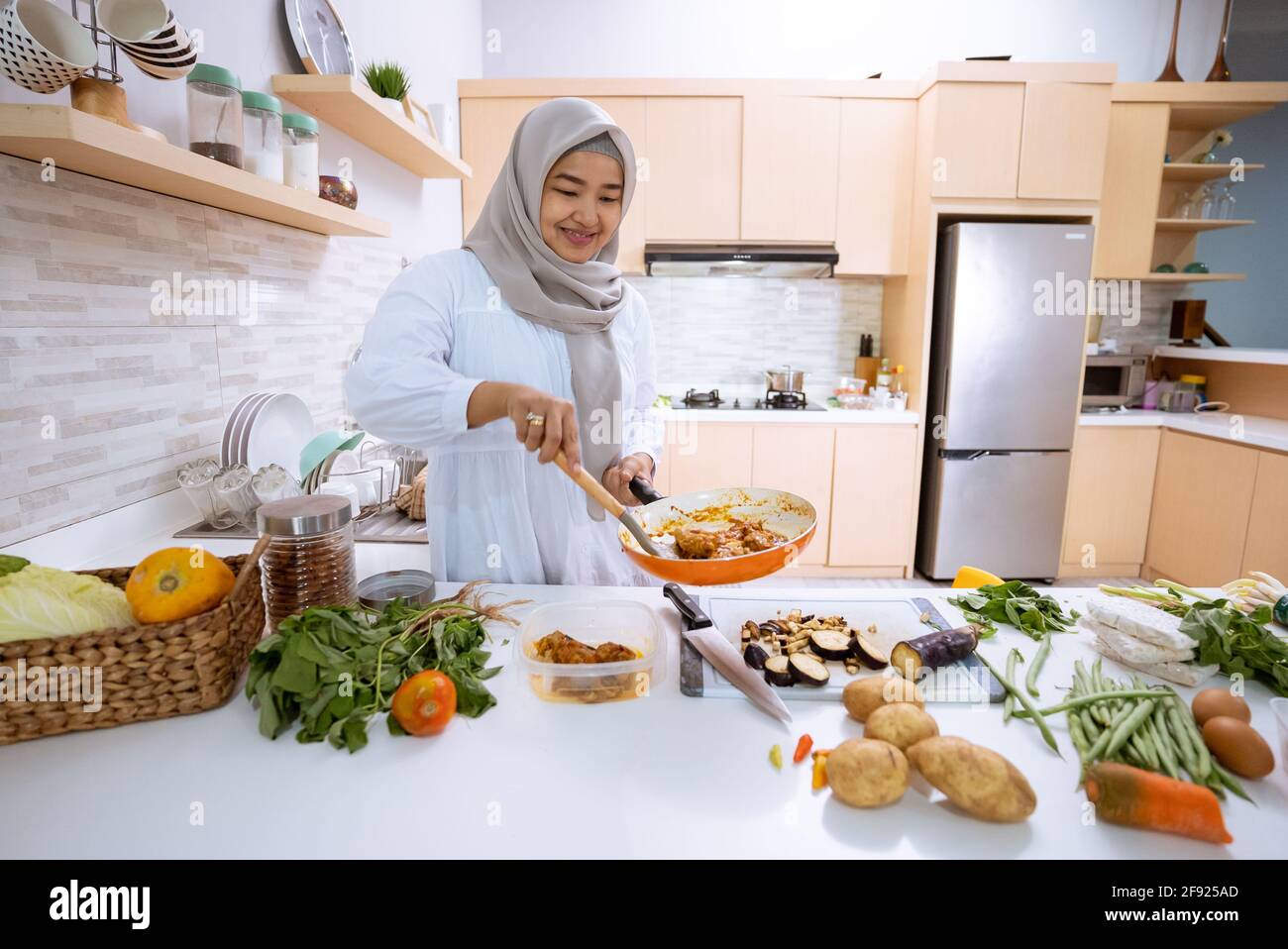 woman with hijab cooking in her house kitchen for dinner Stock Photo ...