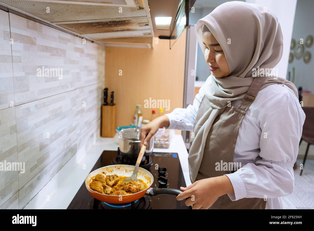 muslim woman preparing iftar dinner cooking in the kitchen Stock Photo ...