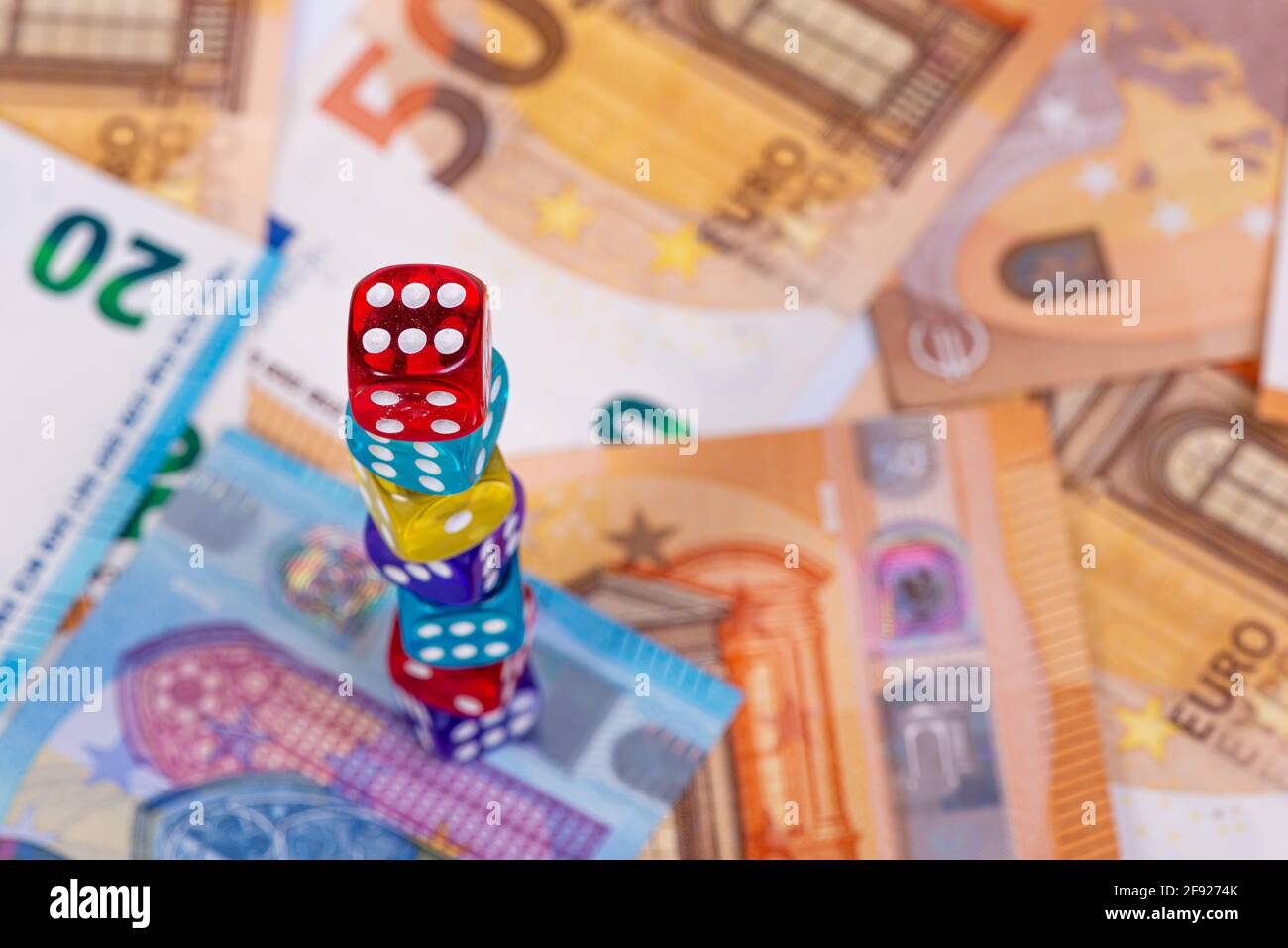 pyramid of dice on the background of euro banknotes, business risk and ...