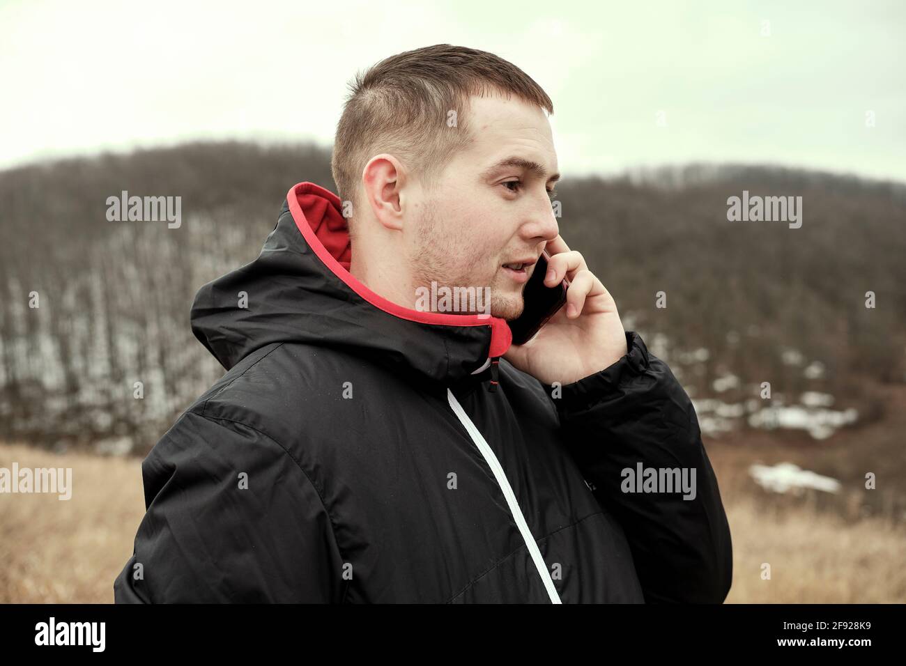 the guy is talking on the phone near the forest. Communication quality ...
