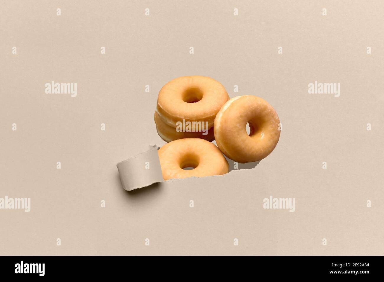 Delicious donut appearing through a broken cardboard. Sweet food ...