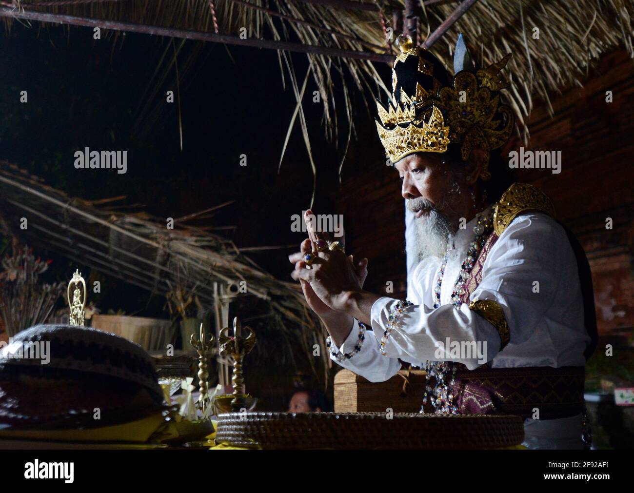 A Balinese Hindu priest conducting a spiritual ceremony during a temple ...