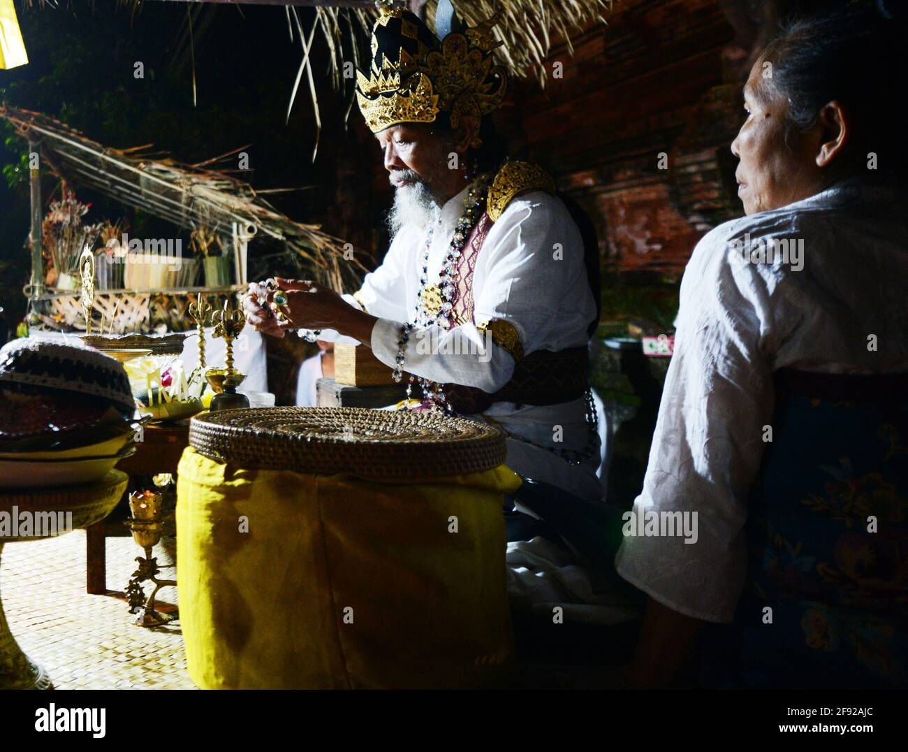 A Balinese Hindu priest conducting a spiritual ceremony during a temple ...