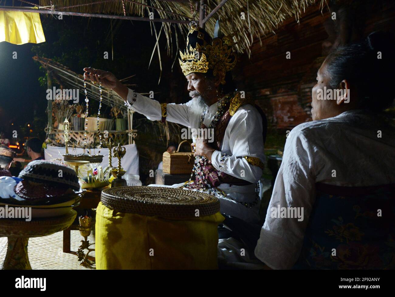 A Balinese Hindu priest conducting a spiritual ceremony during a temple ...
