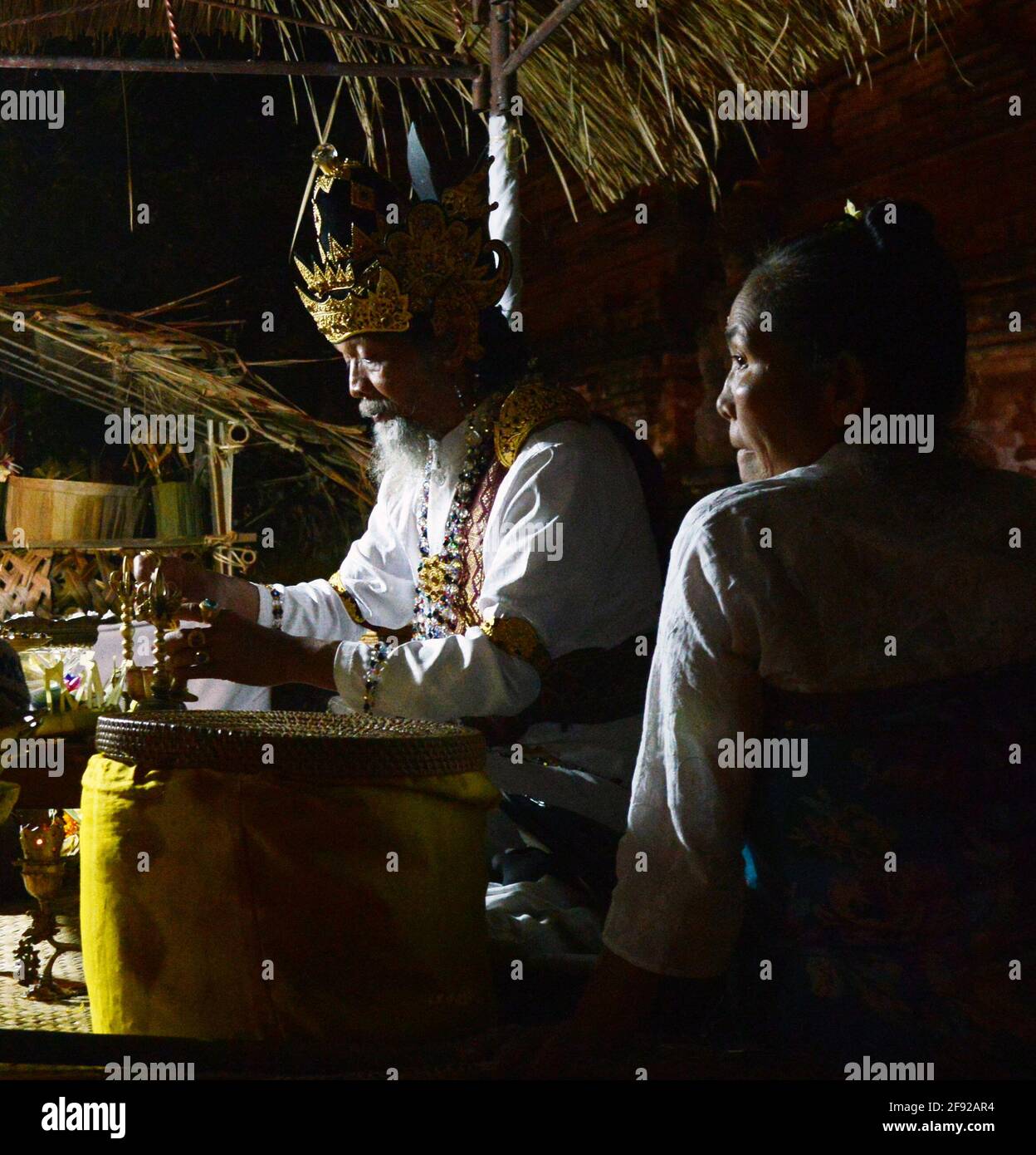 A Balinese Hindu priest conducting a spiritual ceremony during a temple ...