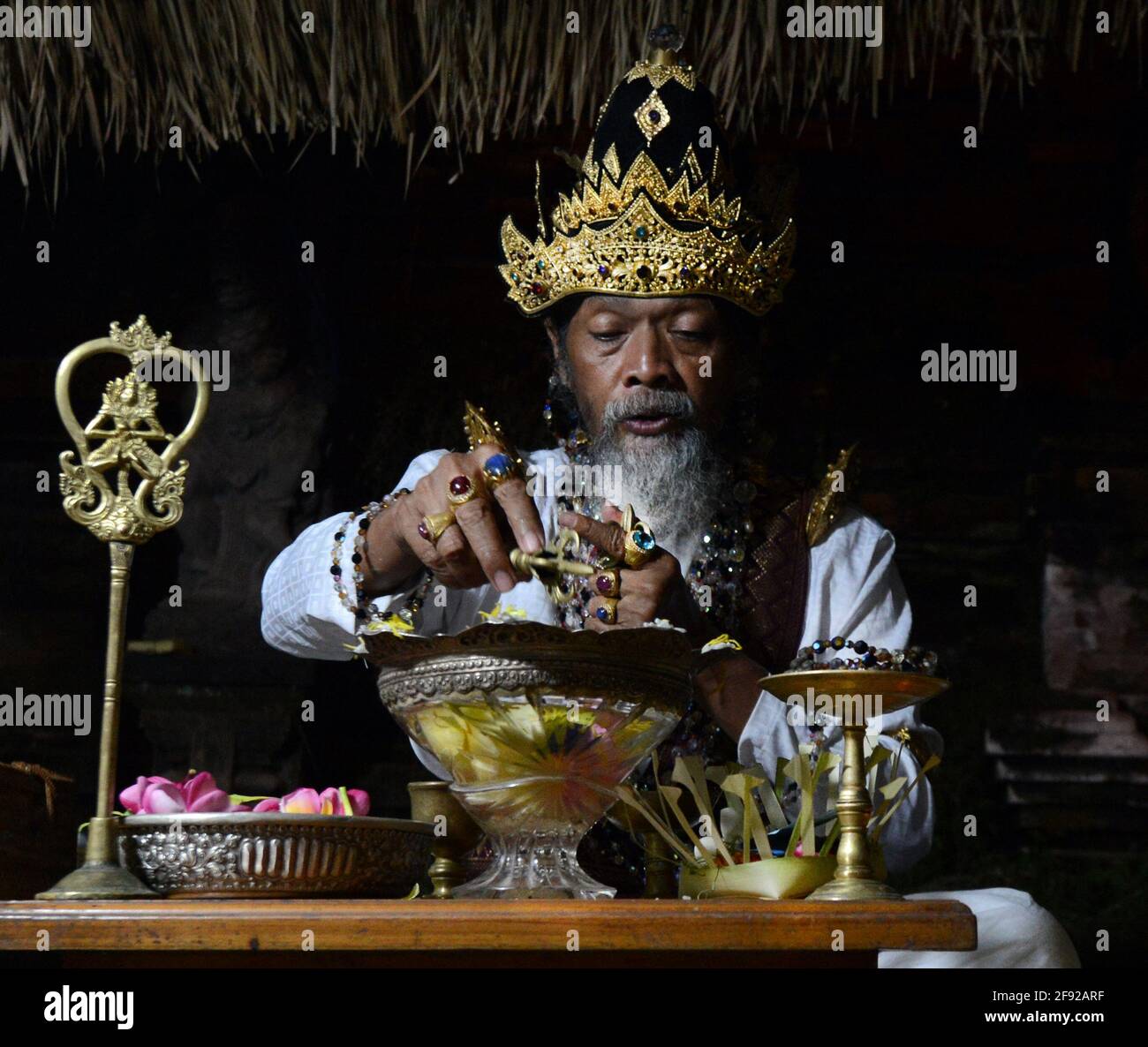 A Balinese Hindu priest conducting a spiritual ceremony during a temple ...