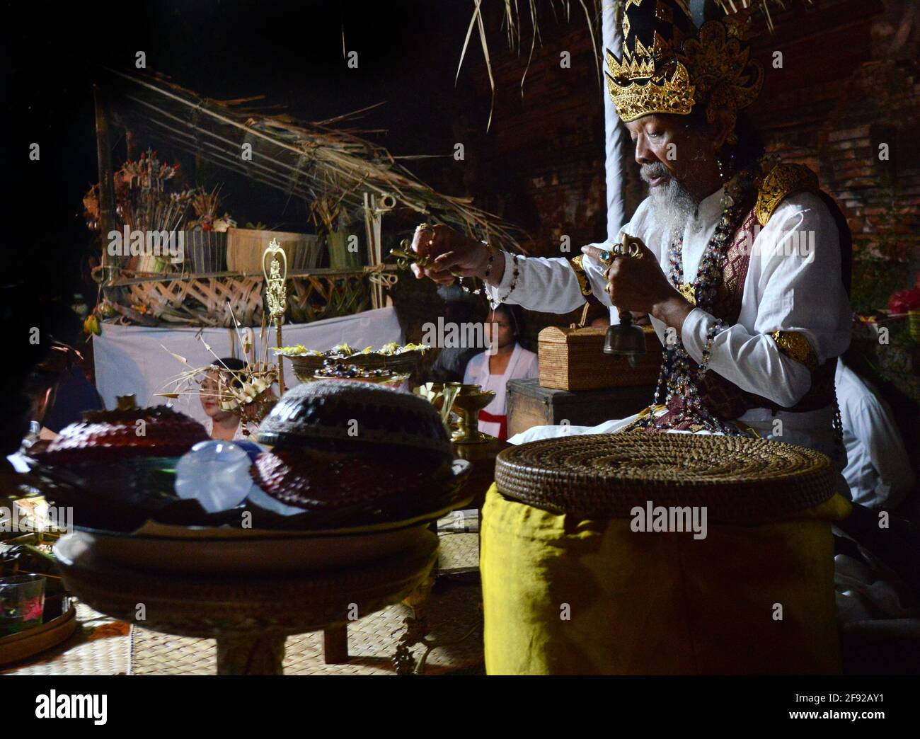 A Balinese Hindu priest conducting a spiritual ceremony during a temple ...