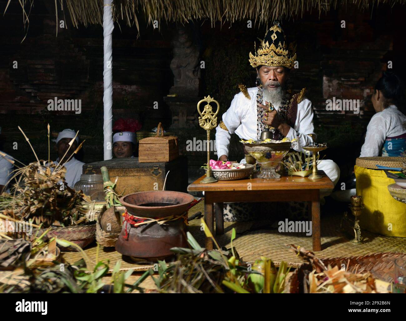 A Balinese Hindu priest conducting a spiritual ceremony during a temple ...
