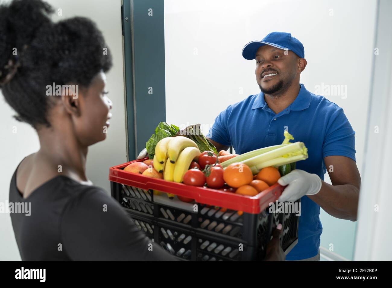 Online Order Food Delivery. African Man With Grocery Crate Stock Photo ...