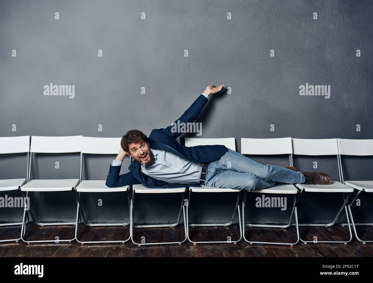 man lying on white chairs work emotions dismissal professional Stock ...