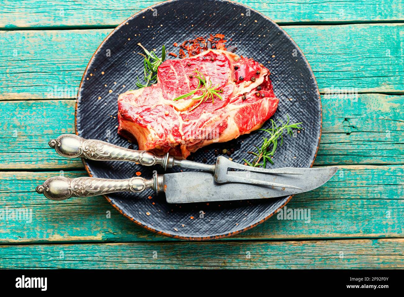 Raw beef meat with rosemary and spices.Uncooked beef steak Stock Photo ...