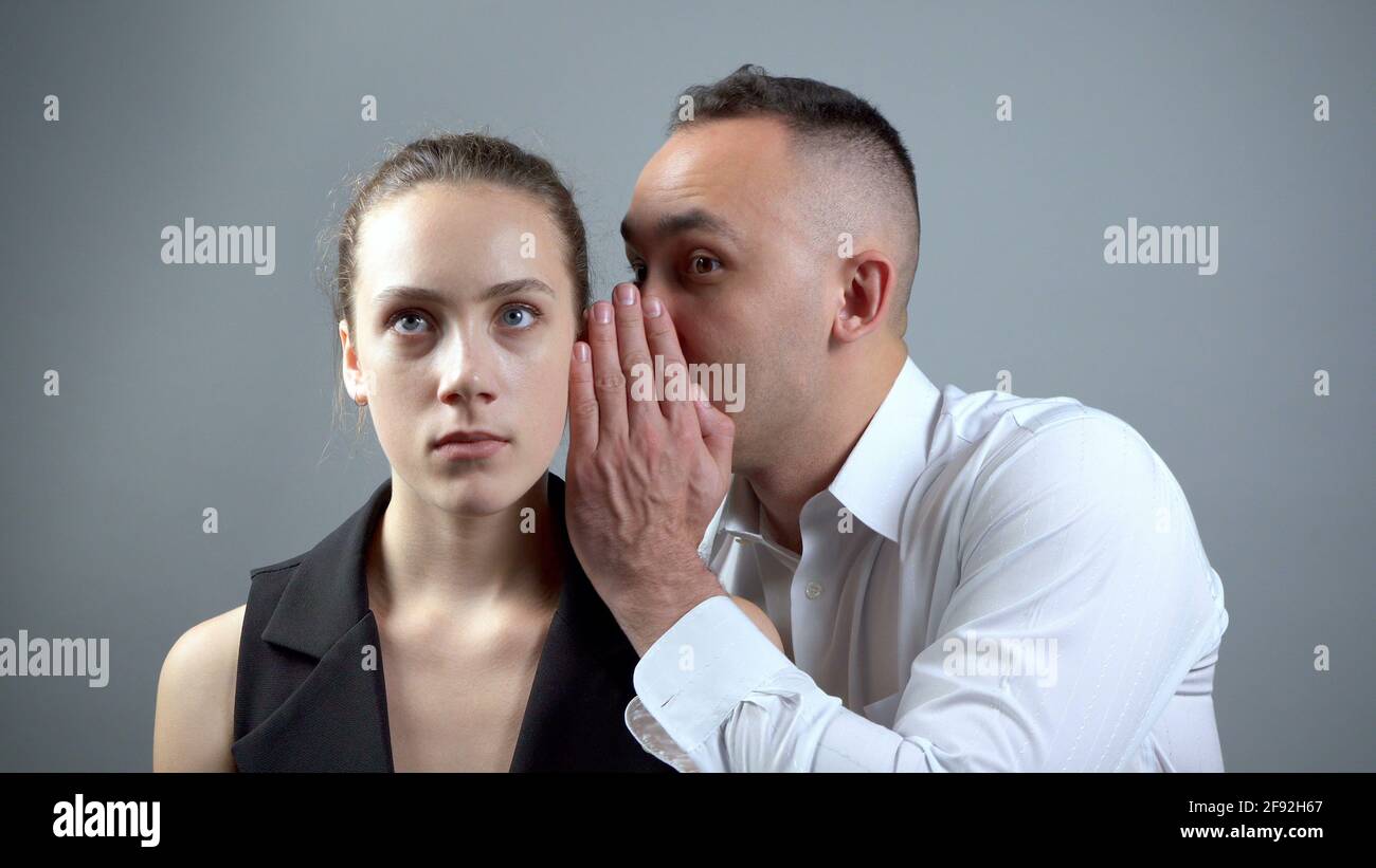 Photo of two gossipers on grey background Stock Photo - Alamy