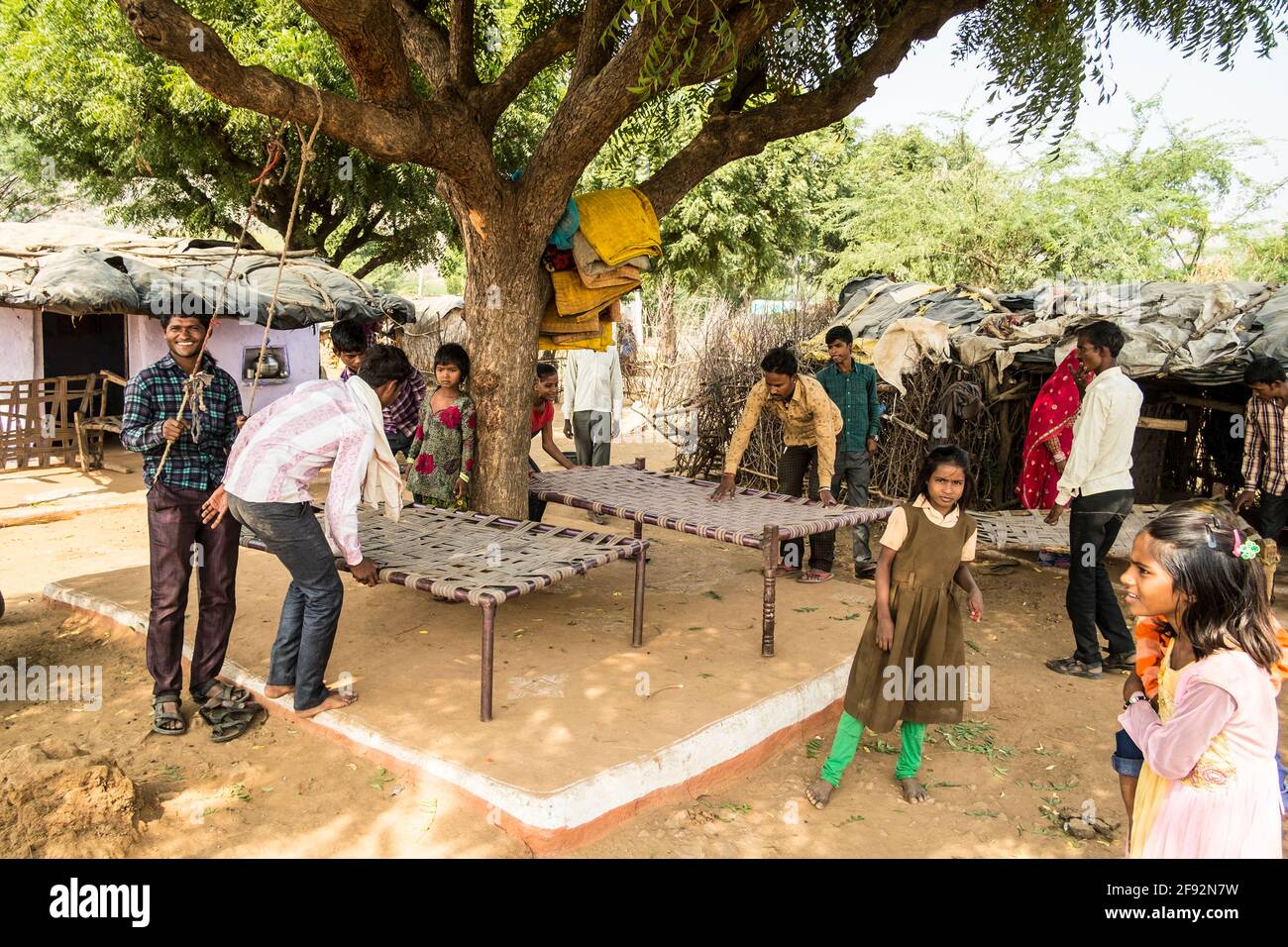 Villagers from rural tribal hamlet in Rajasthan, India, prepare two ...