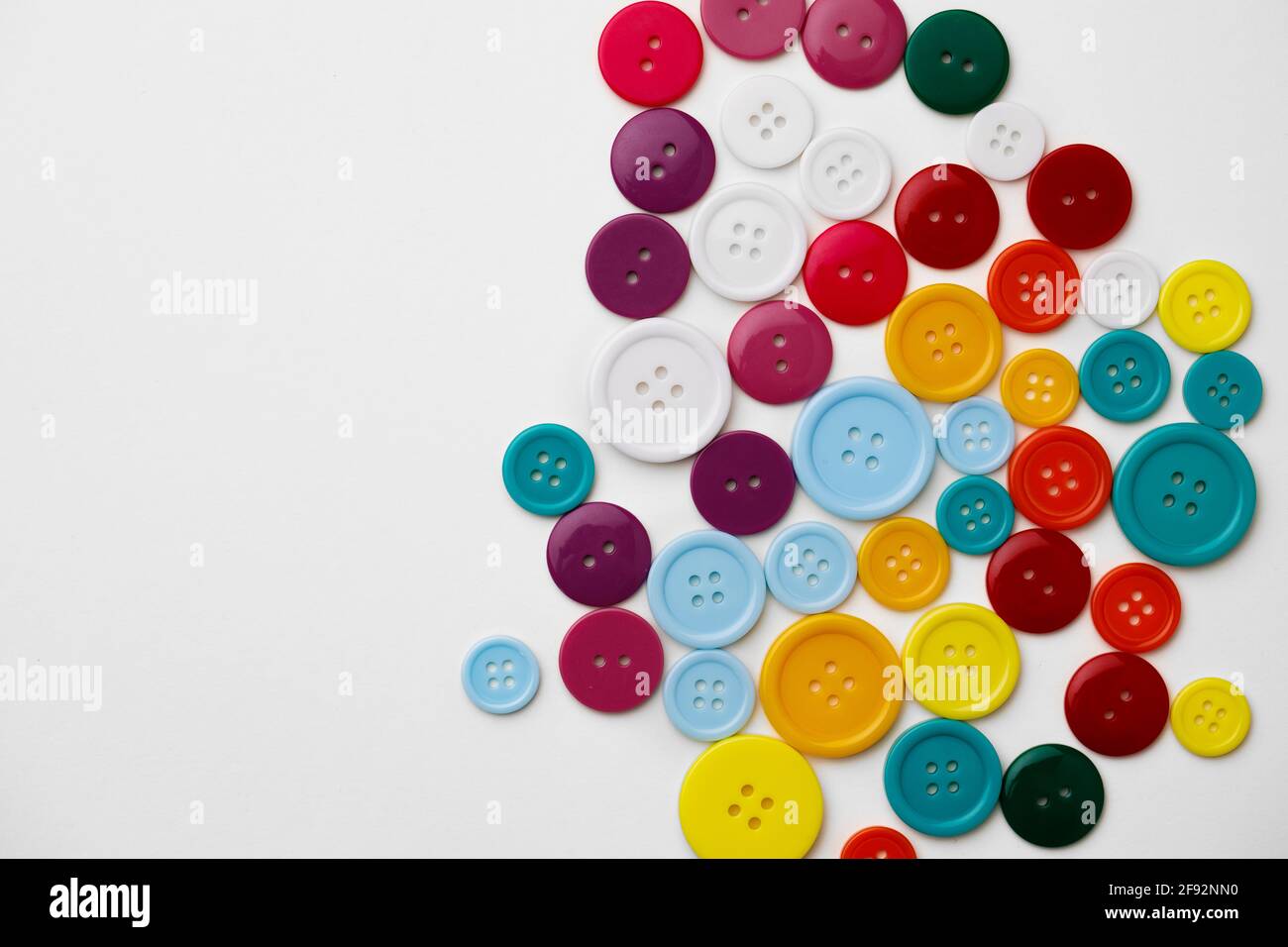 Assortment of colorful buttons on white background Stock Photo - Alamy