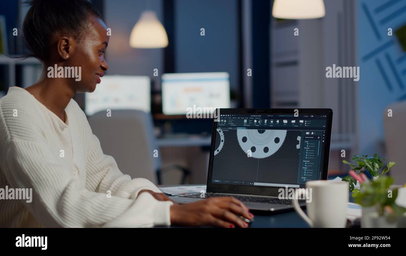 Excited black woman industry architect working on modern cad program ...