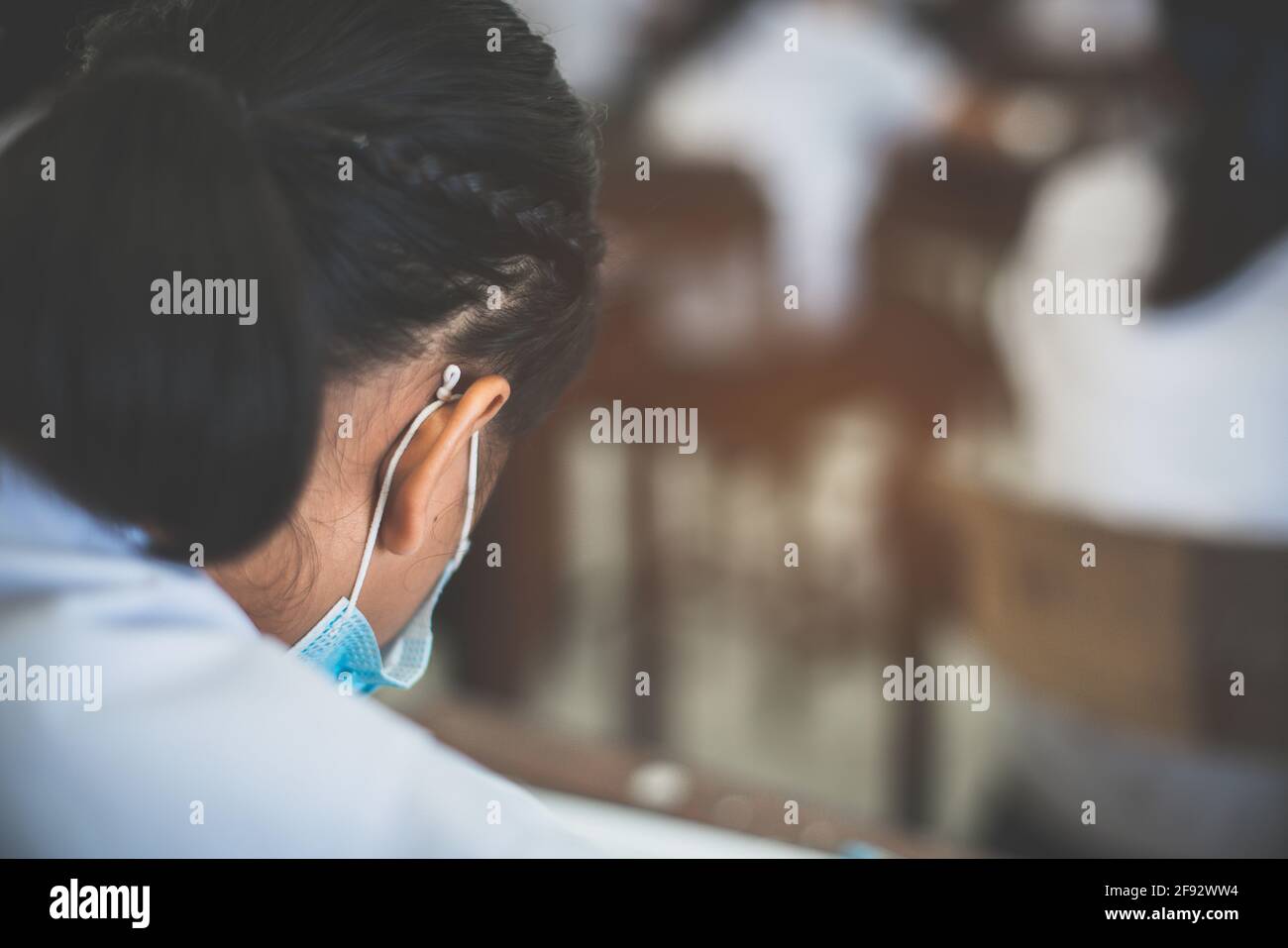 Students wearing mask for protect covid-19 and doing exam in classroom ...