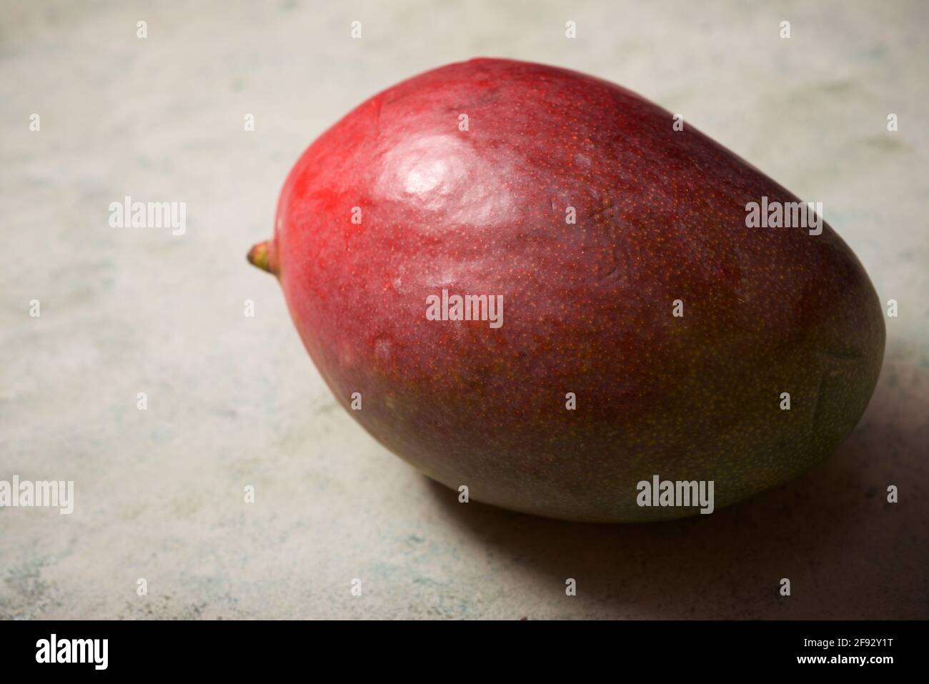 Ripe mango on a stone table Stock Photo - Alamy