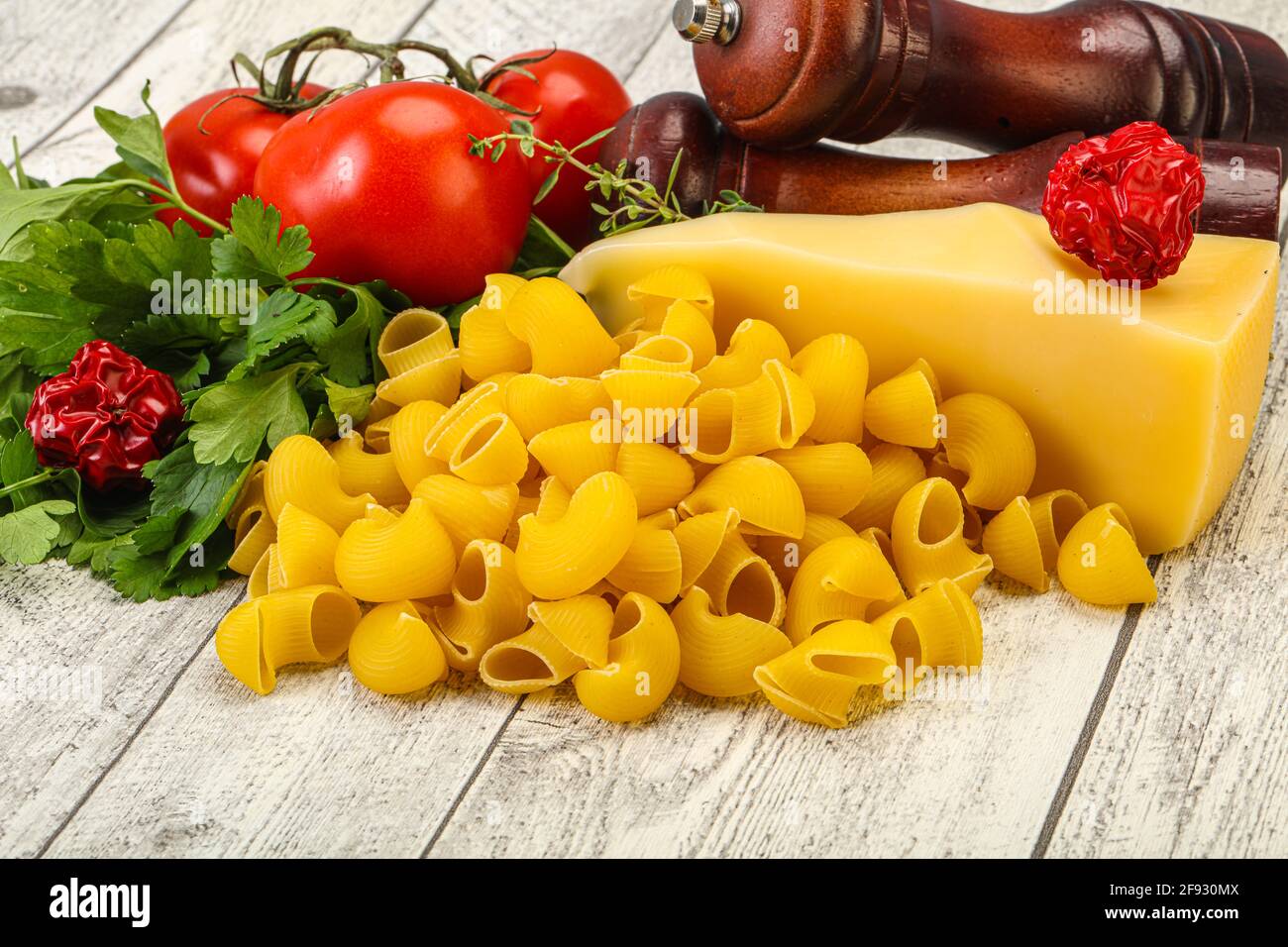 Italian pasta - raw pipe rigate served vegetables Stock Photo - Alamy