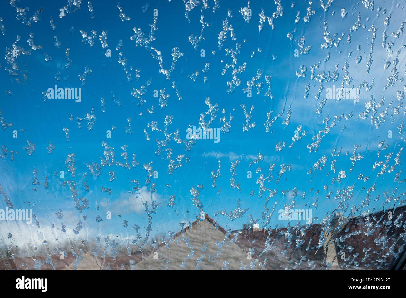 melted snow on the glass of a skylight after a winter shower Stock ...