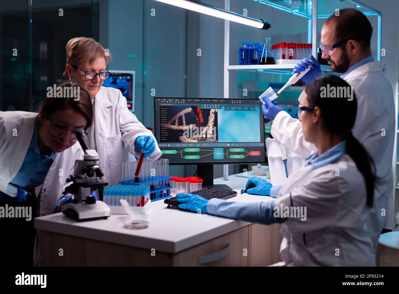Team of scientist working on DNA, analyzing blood sample and using ...