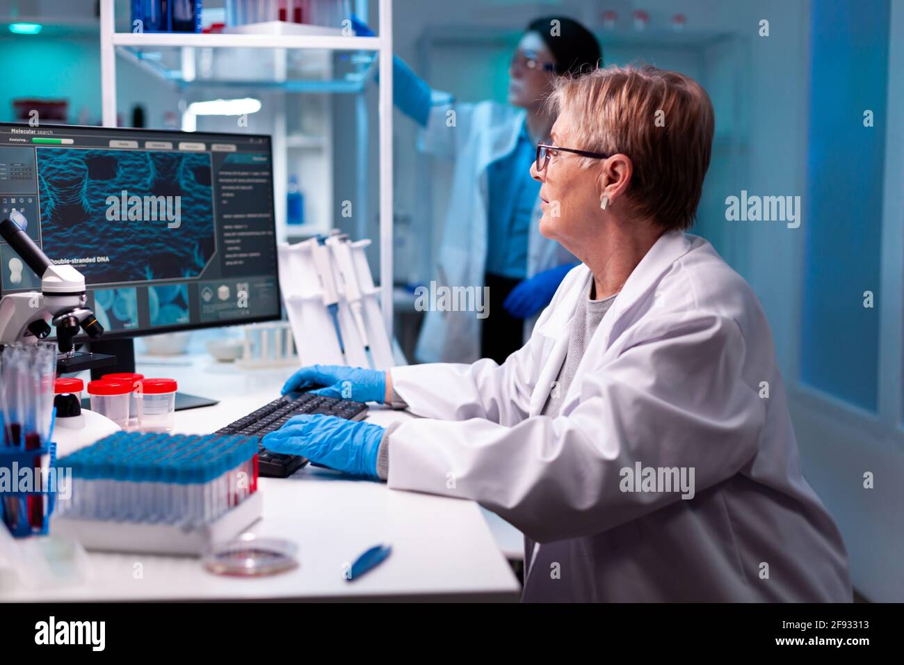 Senior scientist in chemical science laboratory study with team, test ...