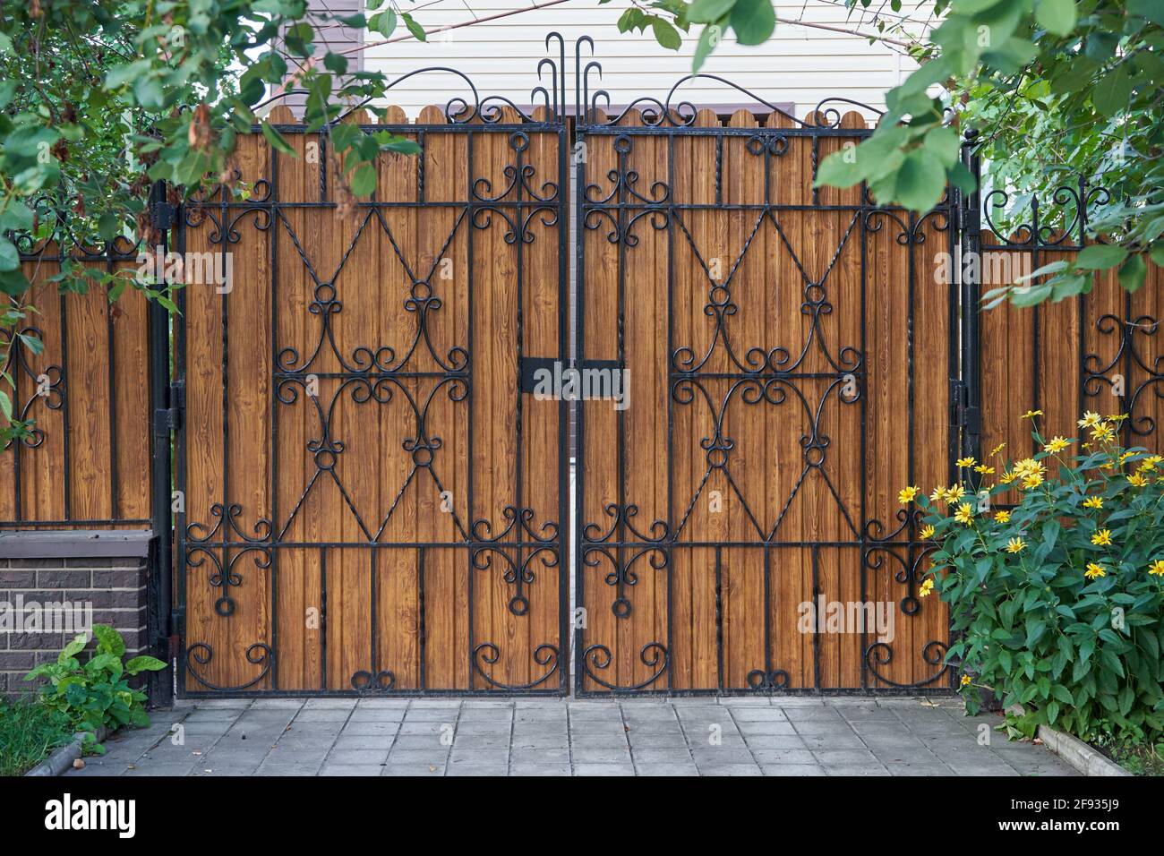 Brown metal gates with decorative elements Stock Photo - Alamy