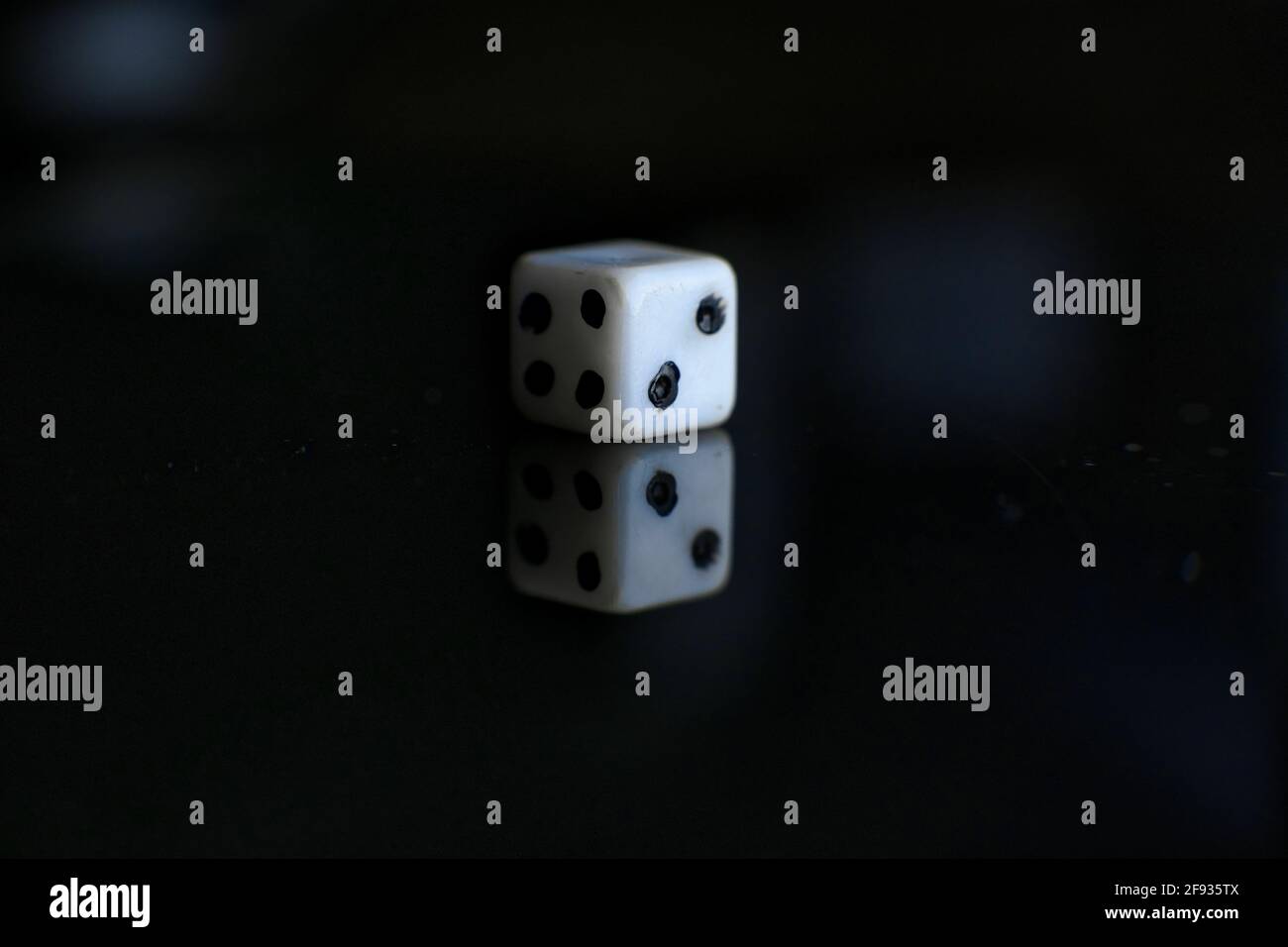 Dice and its reflection on the black glassy surface - perfect for ...