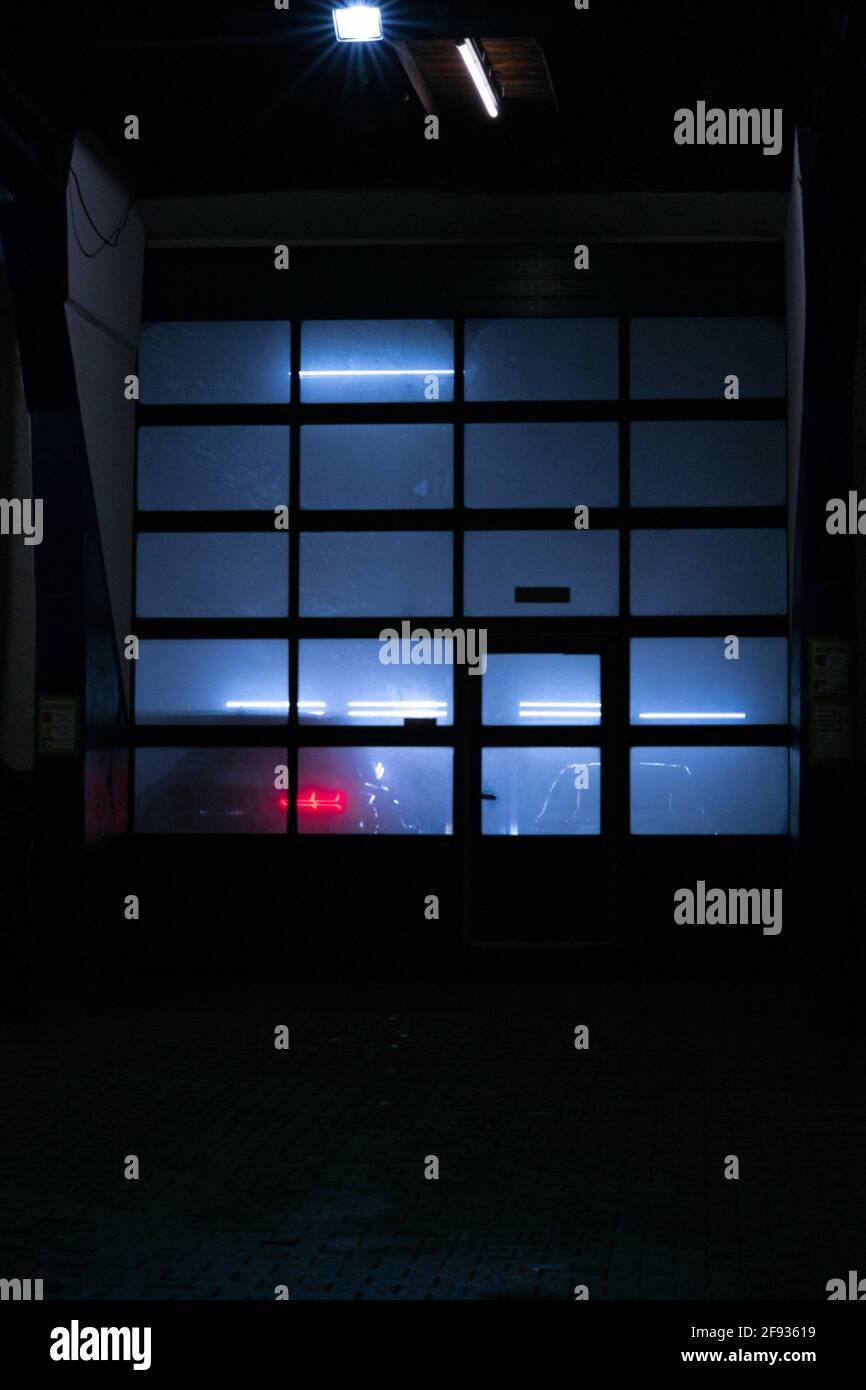 Vertical shot of a parking lot with windows under the lamp lights at ...