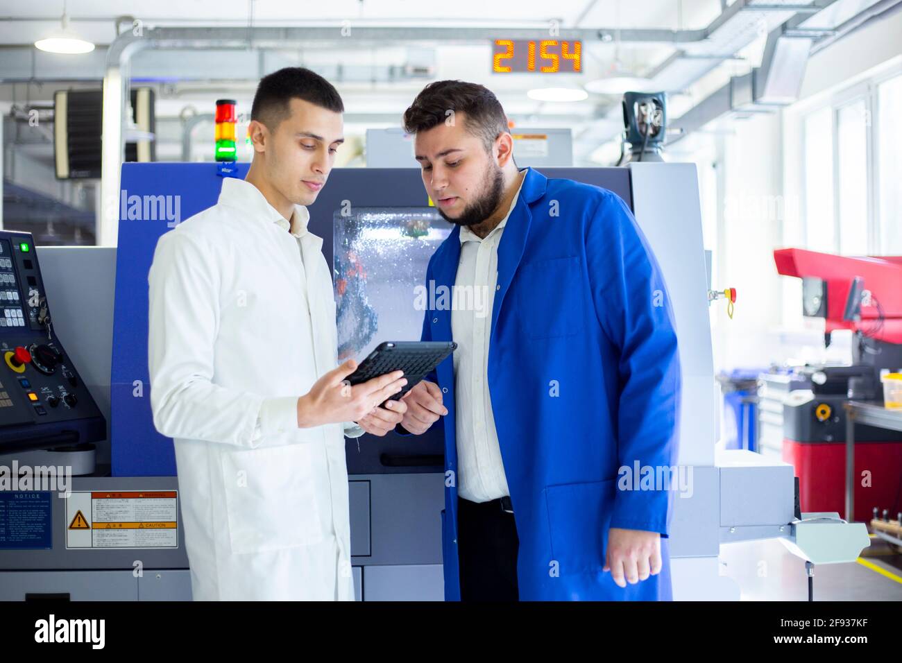 Engineer and technician discussing production process at factory Stock ...