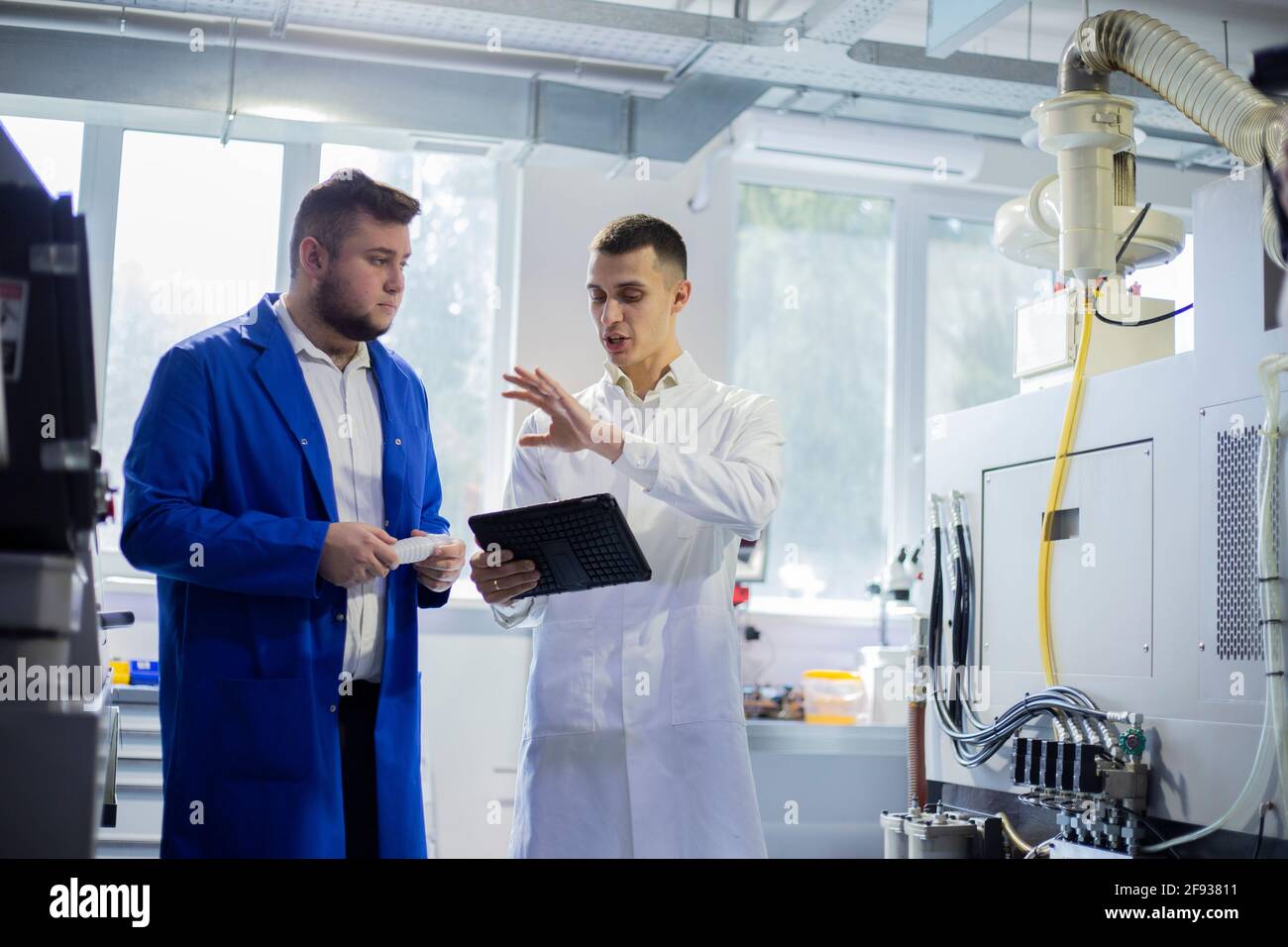 Engineer and technician discussing production process at factory Stock ...