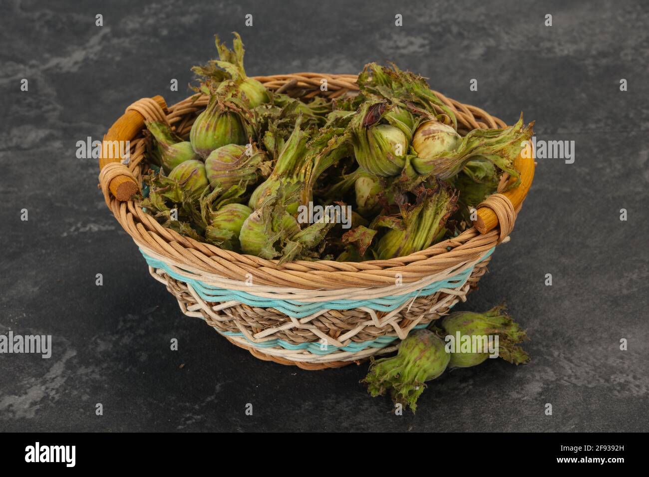 Young Hazel nuts in the basket Stock Photo - Alamy