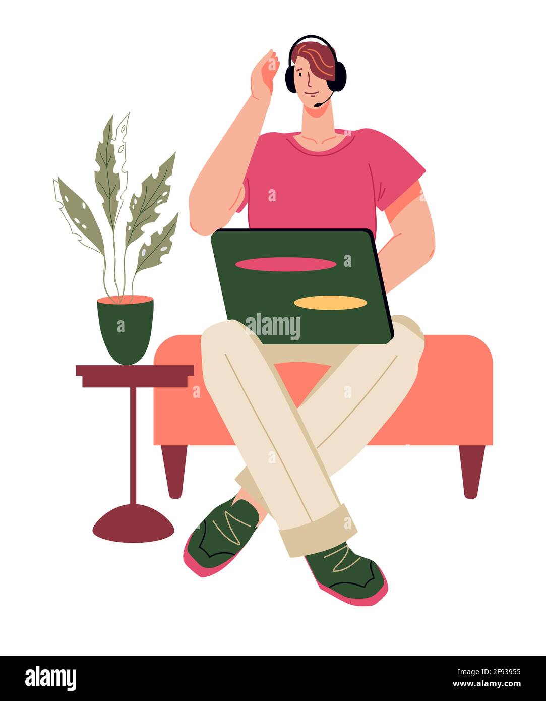 Young man sits in a chair and works remotely from home on a laptop ...