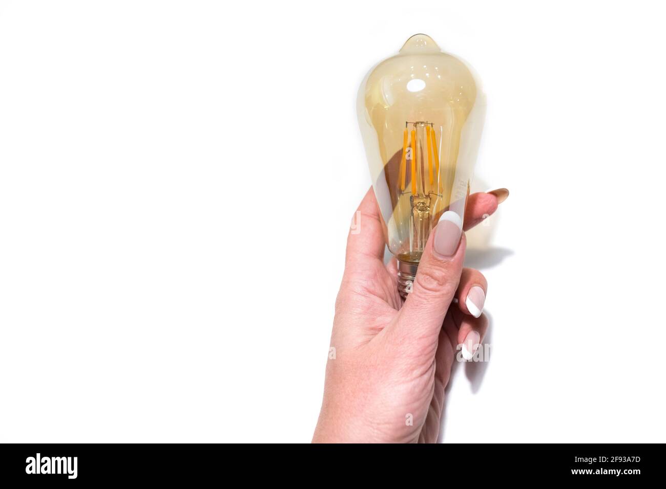 Electric diode light bulb in hand, isolated on white studio background ...