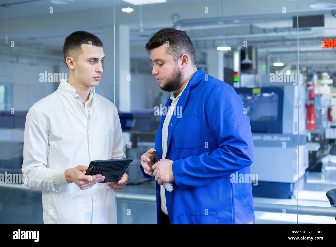 Engineer and technician discussing production process at factory Stock ...
