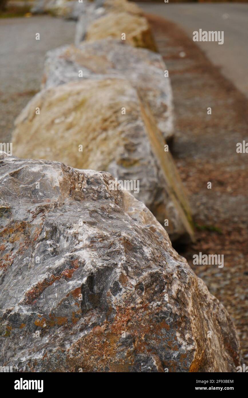 big old stones on a square with gravel stones next to a road Stock ...